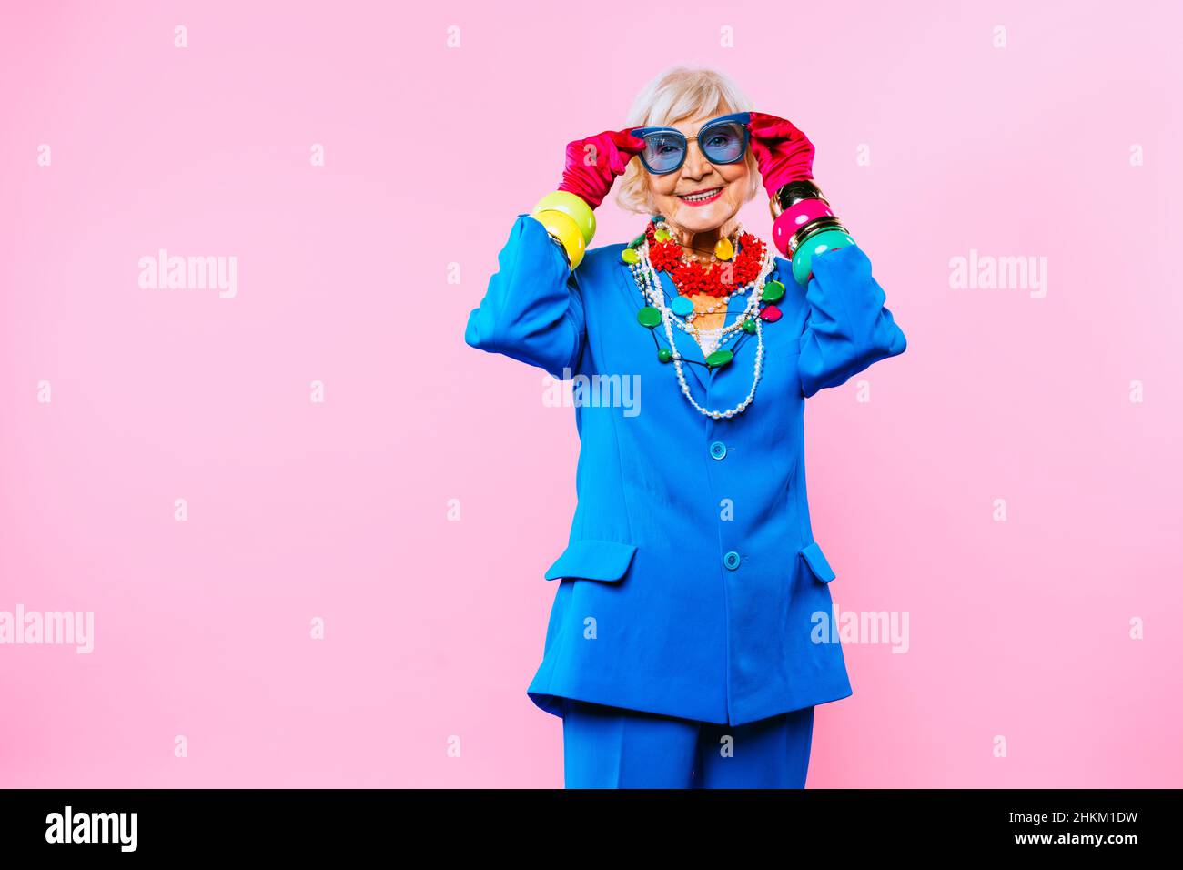 Happy and funny cool old lady with fashionable clothes portrait on ...