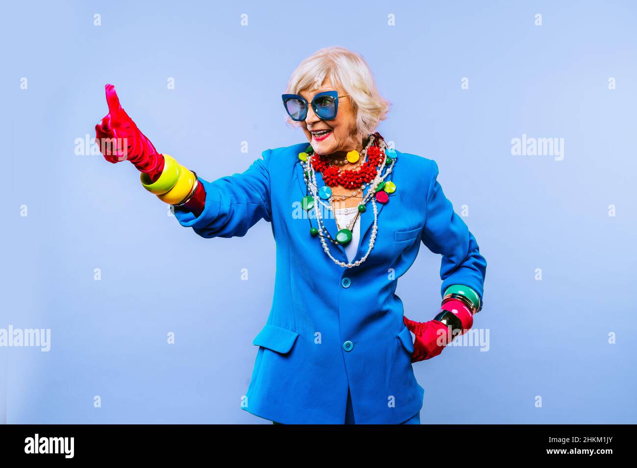 Happy and funny cool old lady with fashionable clothes portrait on ...
