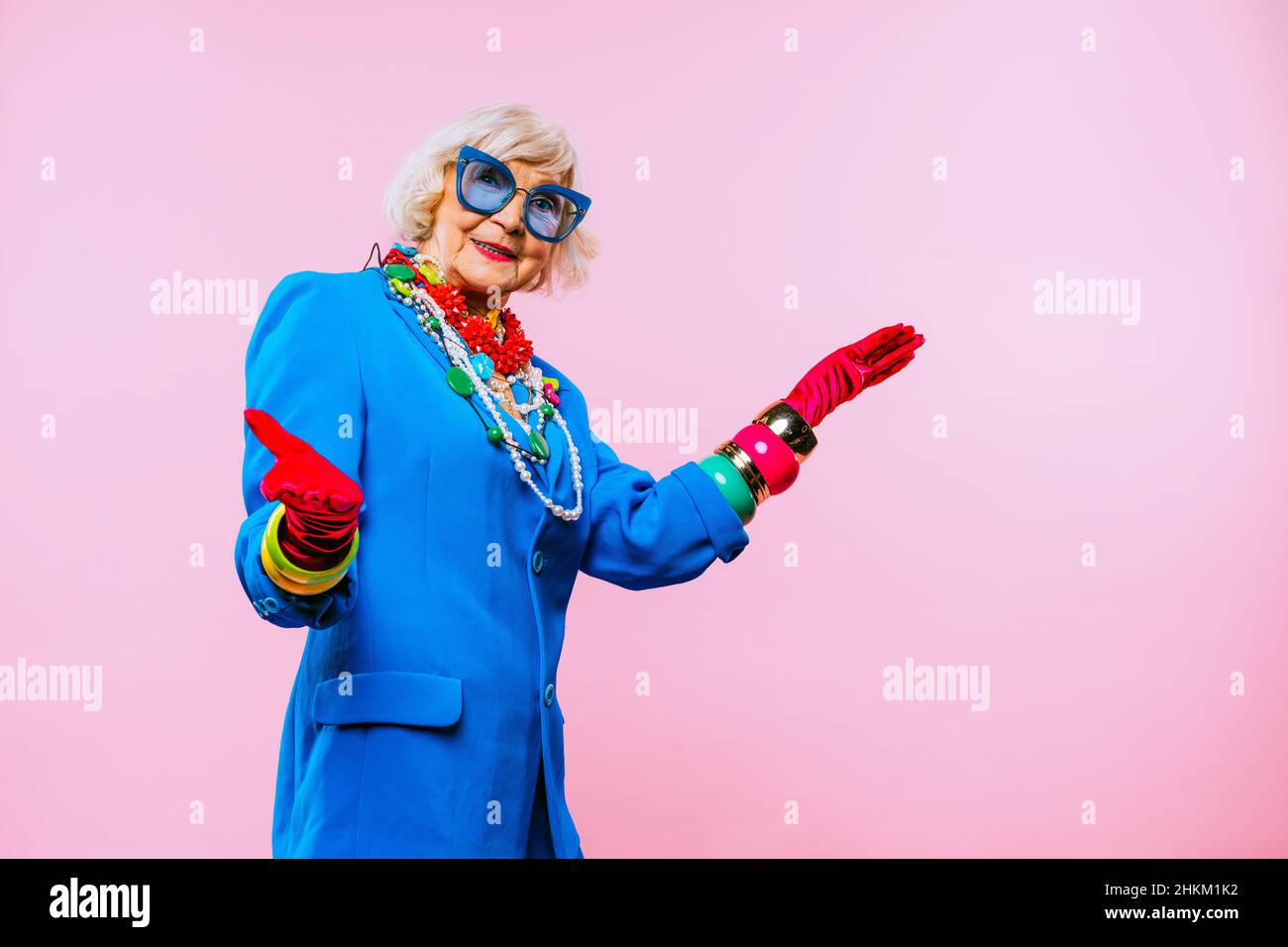 Happy and funny cool old lady with fashionable clothes portrait on ...