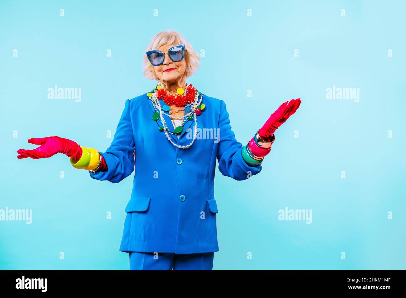 Happy and funny cool old lady with fashionable clothes portrait on ...