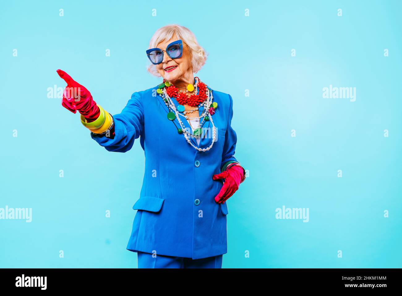 Happy and funny cool old lady with fashionable clothes portrait on ...