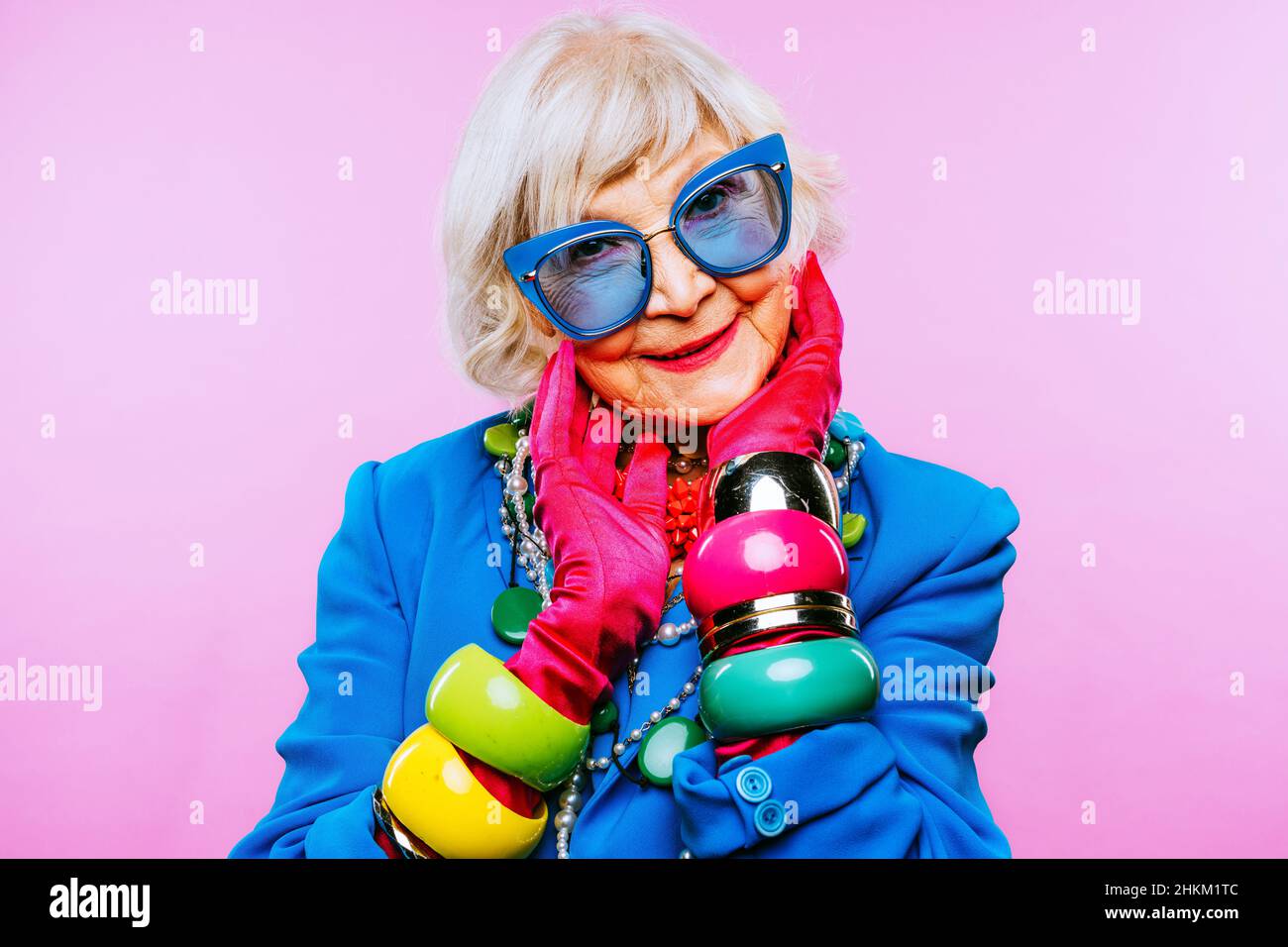 Happy and funny cool old lady with fashionable clothes portrait on ...