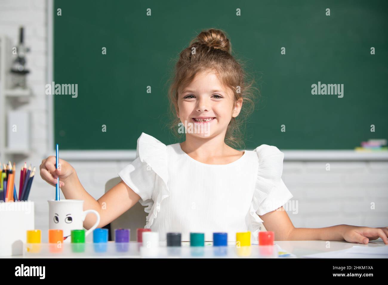 Cute little girl child painting with paints color and brush. Drawing ...