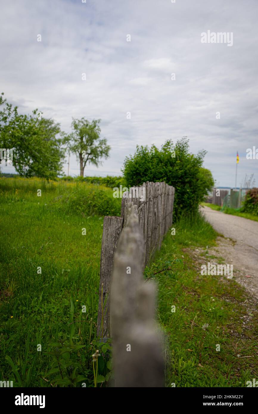Wooden fence on a roadside meadow Stock Photo - Alamy
