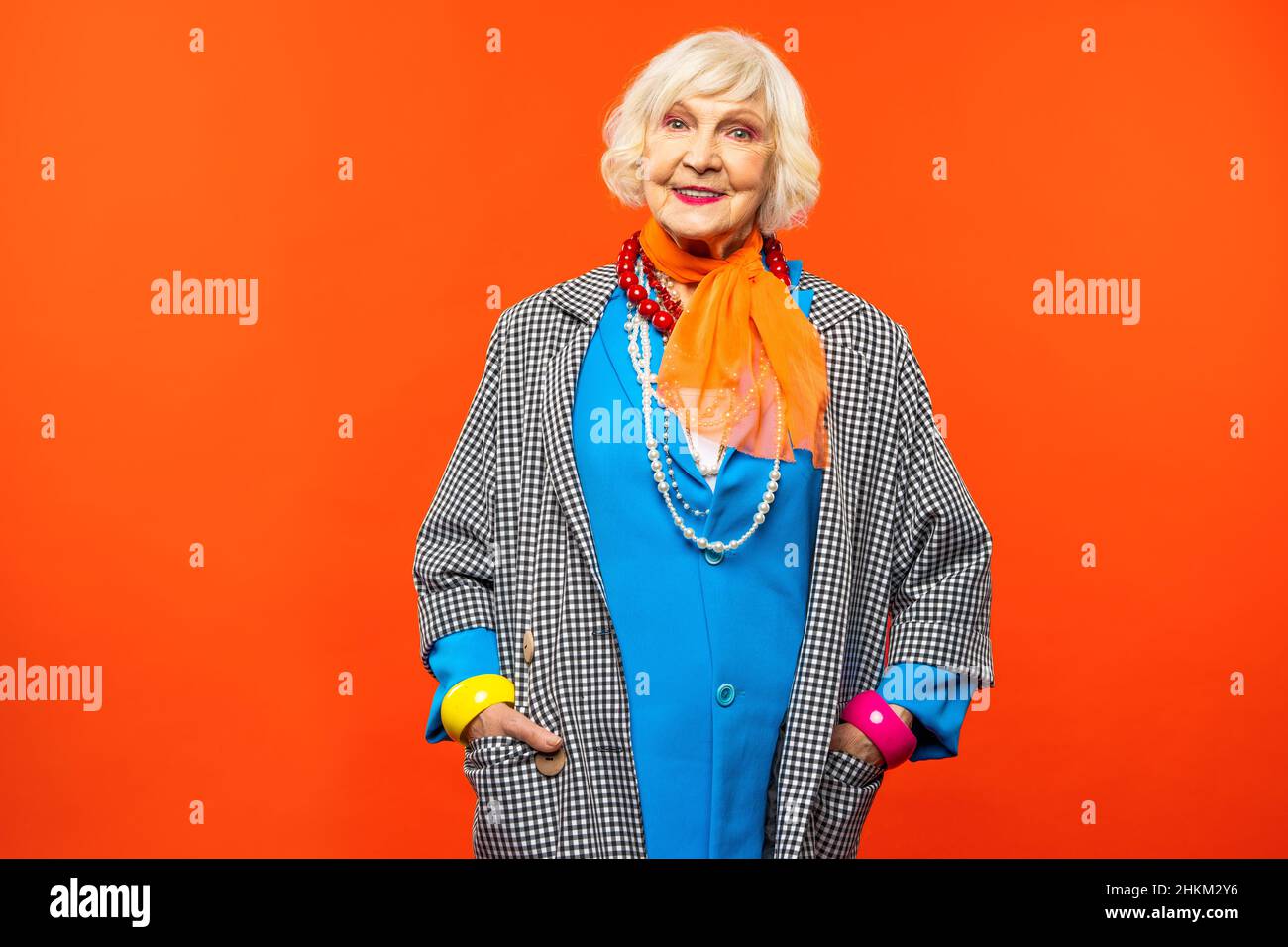 Happy and funny cool old lady with fashionable clothes portrait on ...