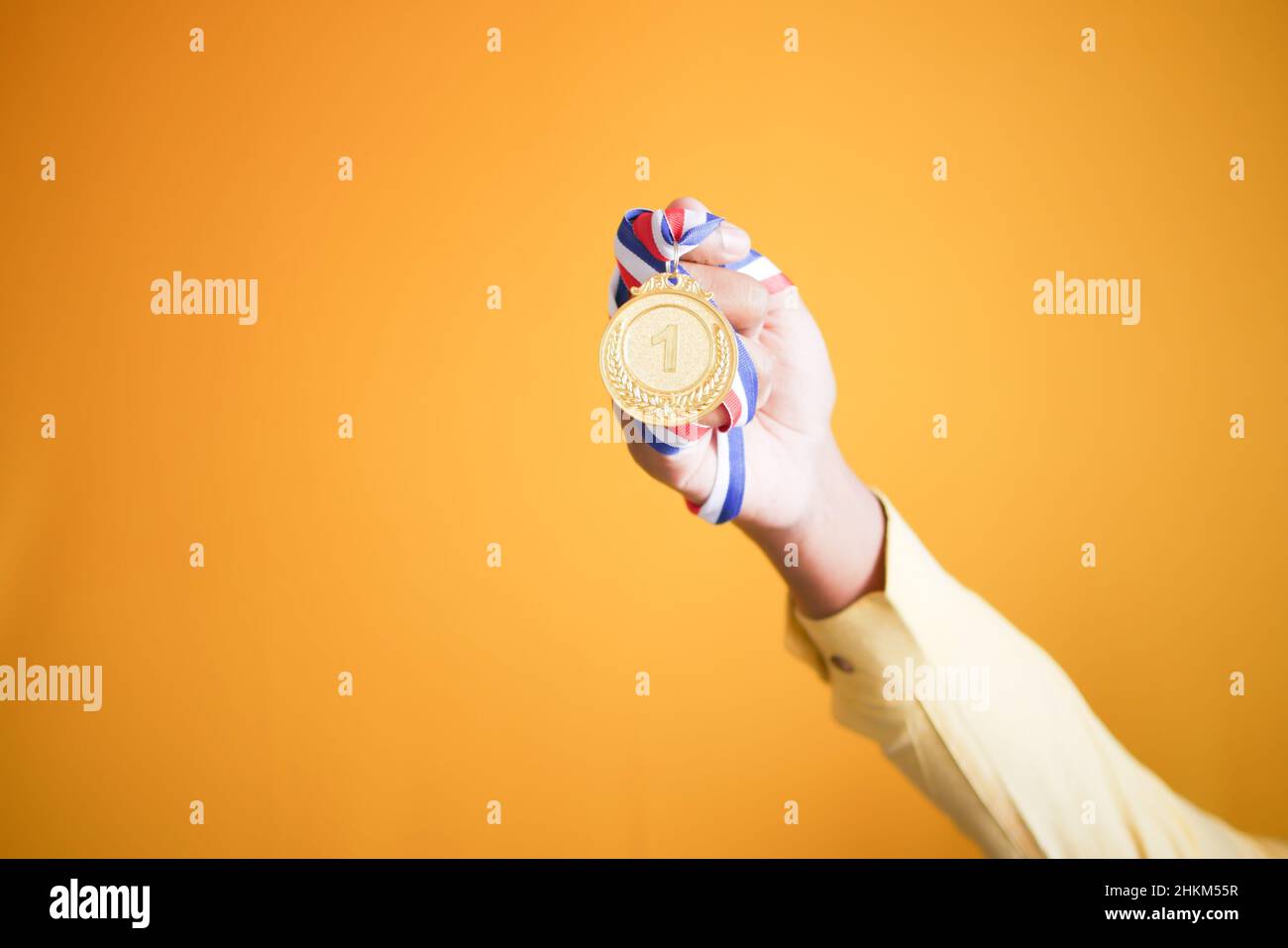 First Place Throphy against yellow background Stock Photo - Alamy