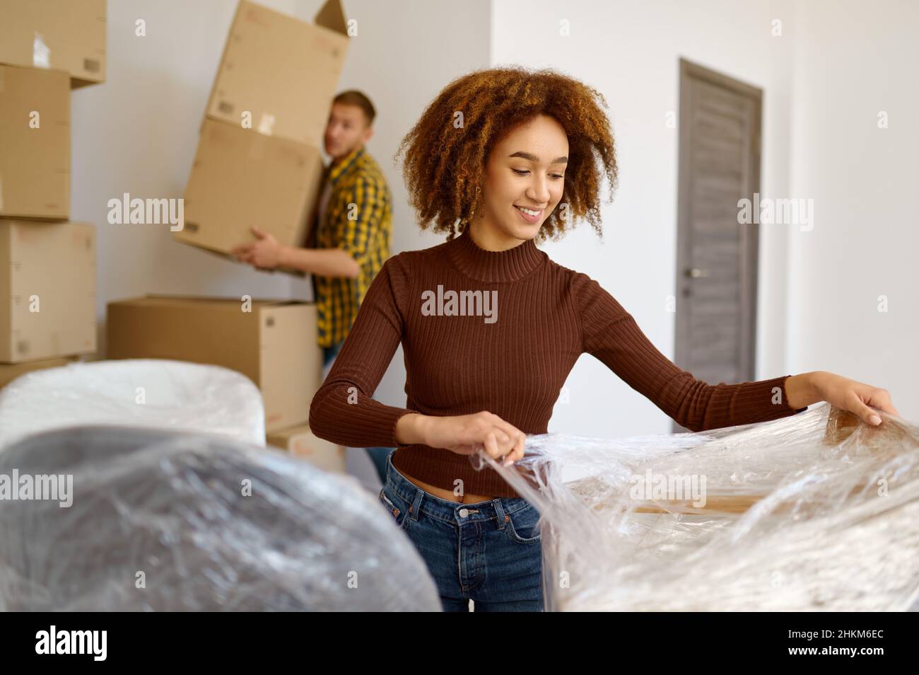Young multiracial couple moving in hi-res stock photography and images ...
