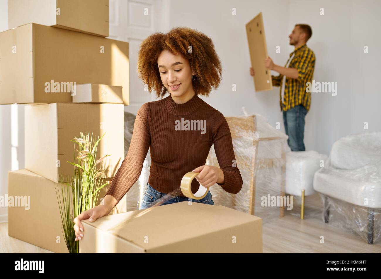 Young couple packing stuff into carton boxes Stock Photo - Alamy