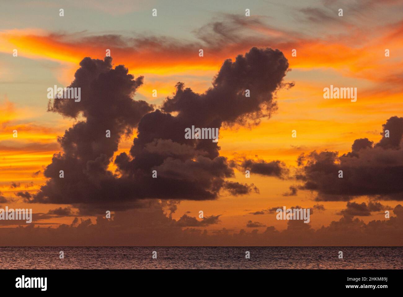 View of the sea with puffy clouds in the sky at the sunset in Glitter ...