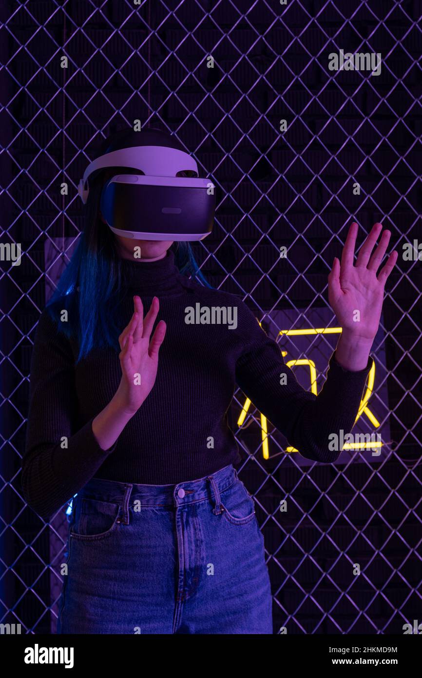 Teen girl using vr headset is in virtual reality cyberspace futuristic ...