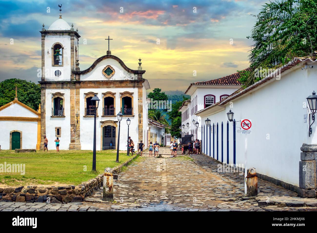 Portuguese style Catholic church facade and cobblestone street. The ...