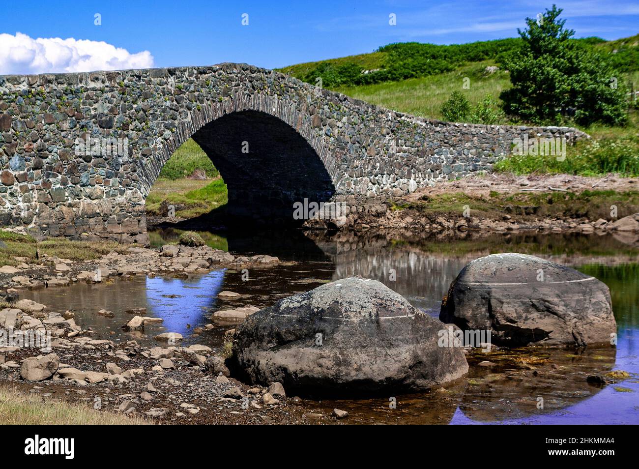 Old humpback bridge crossing the tidal inlet of Leth Fionn, near Grass ...