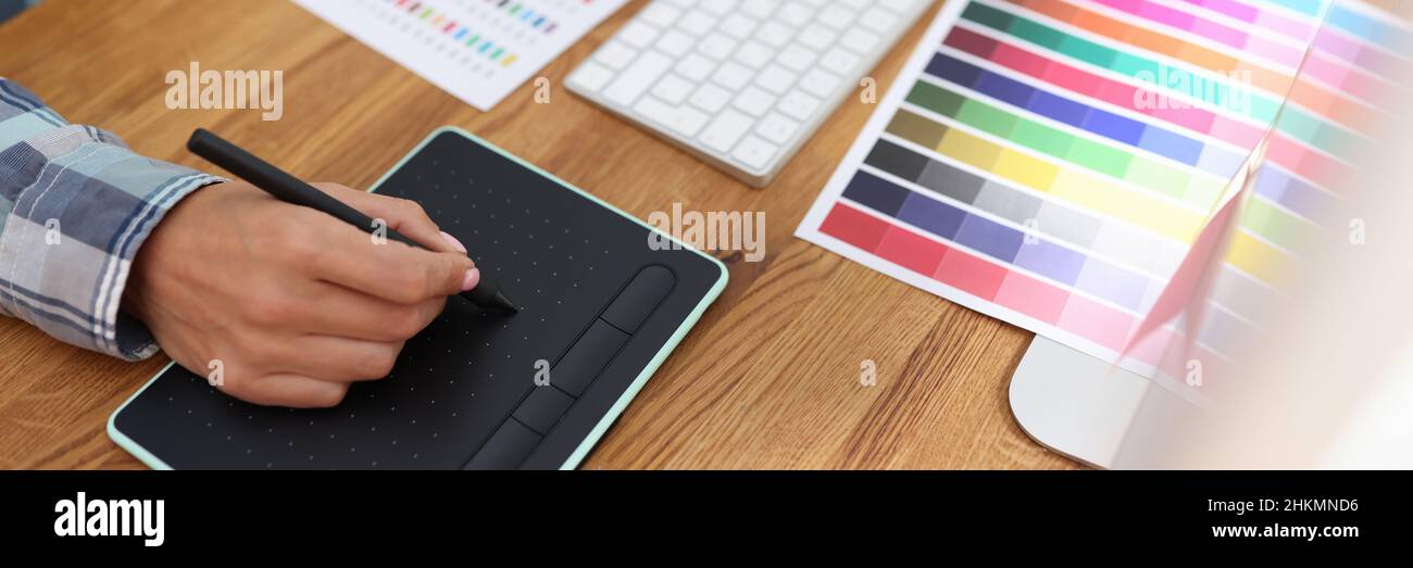 Graphic designer works on computer and selects color schemes Stock ...