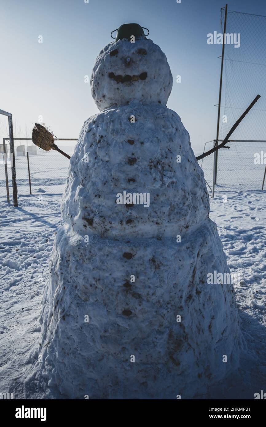 Vertical shot of a snowman in the football arena during winter Stock ...