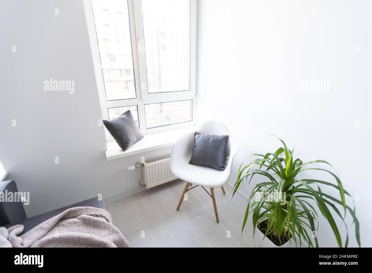 View of an empty wooden chair near the window at sunset in a hotel ...