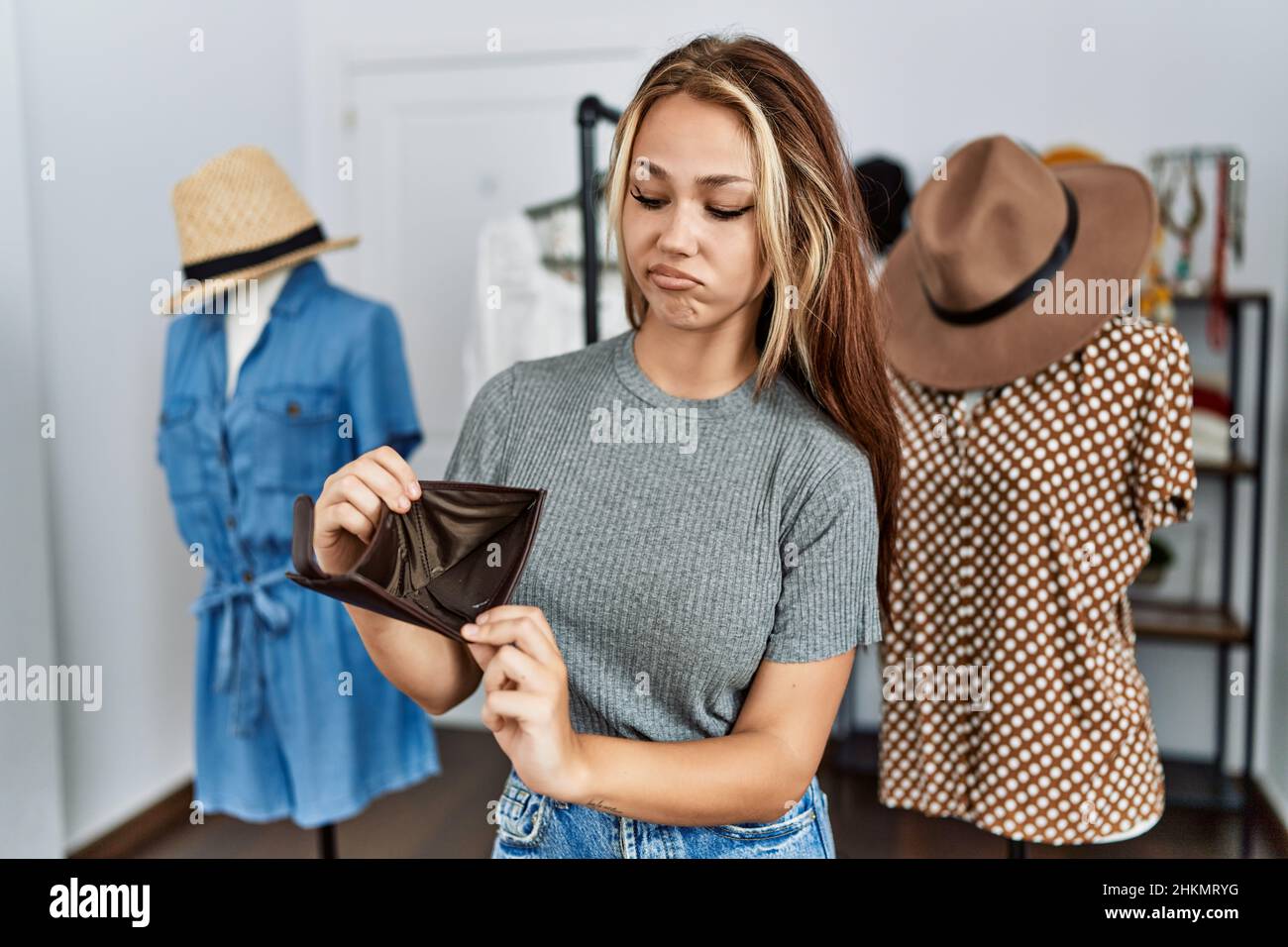 Young caucasian customer woman with unhappy expression showing empty ...