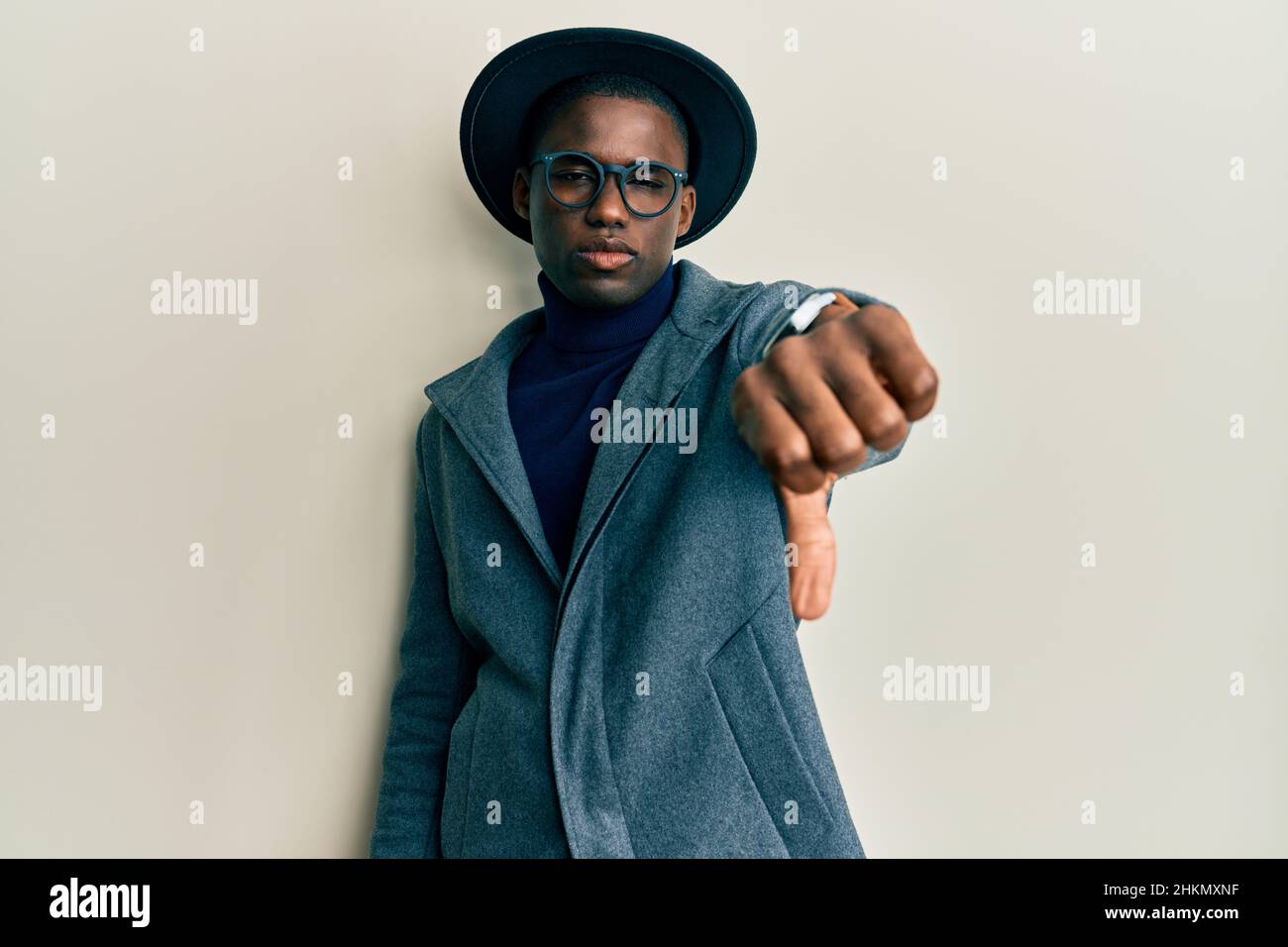 Young african american man wearing elegant style looking unhappy and ...
