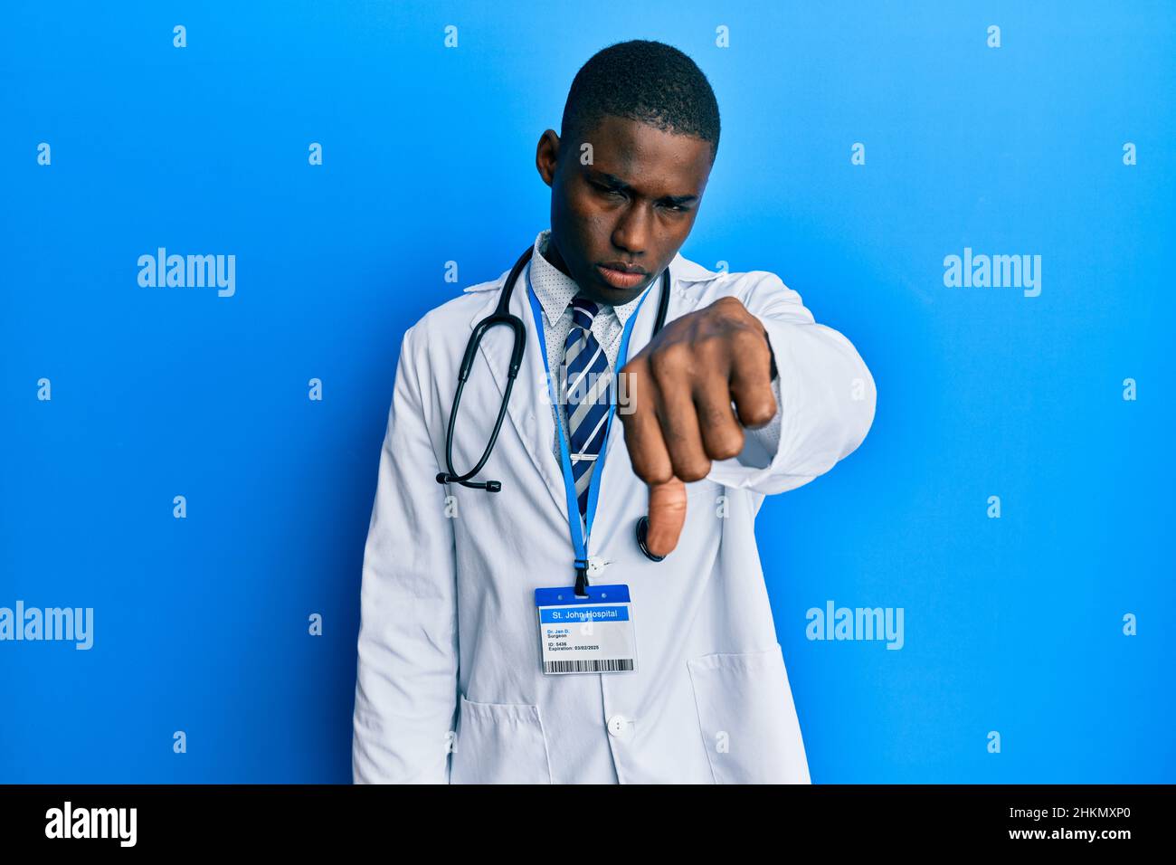 Young african american man wearing doctor uniform looking unhappy and ...