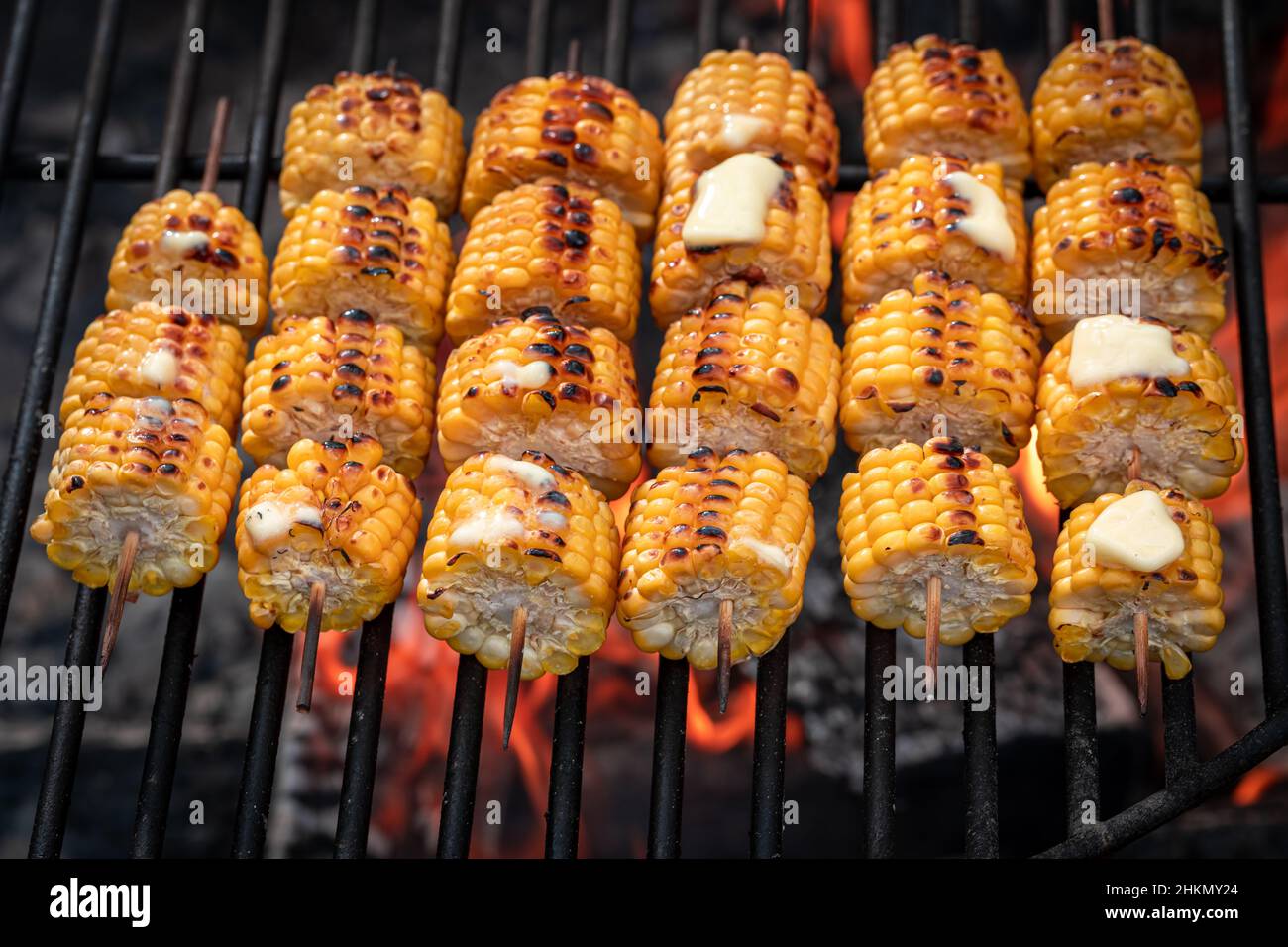 Hot corncob on grill on bonfire with flames. Corn cob roasted on a fire ...