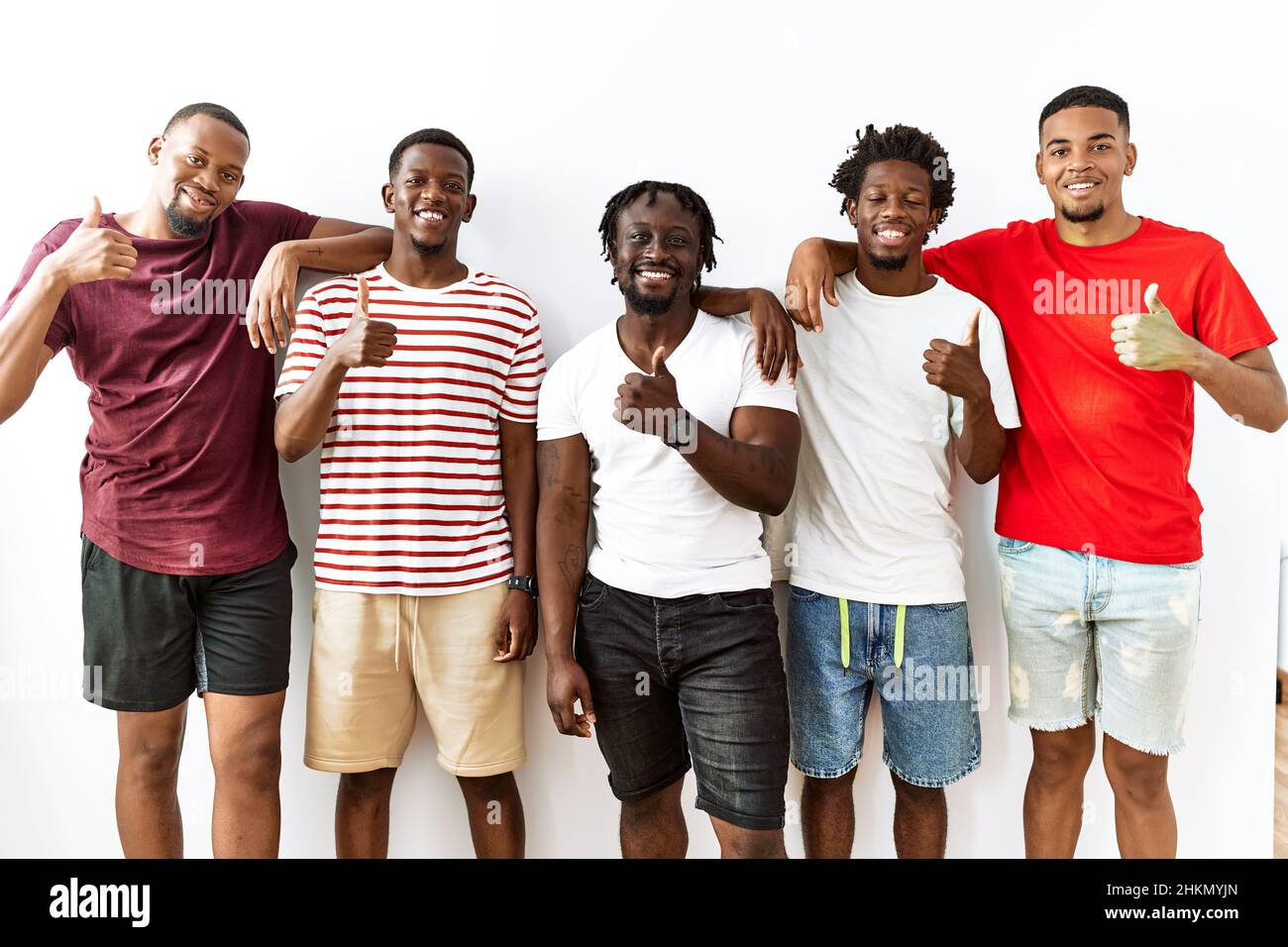 Young african group of friends standing together over isolated ...