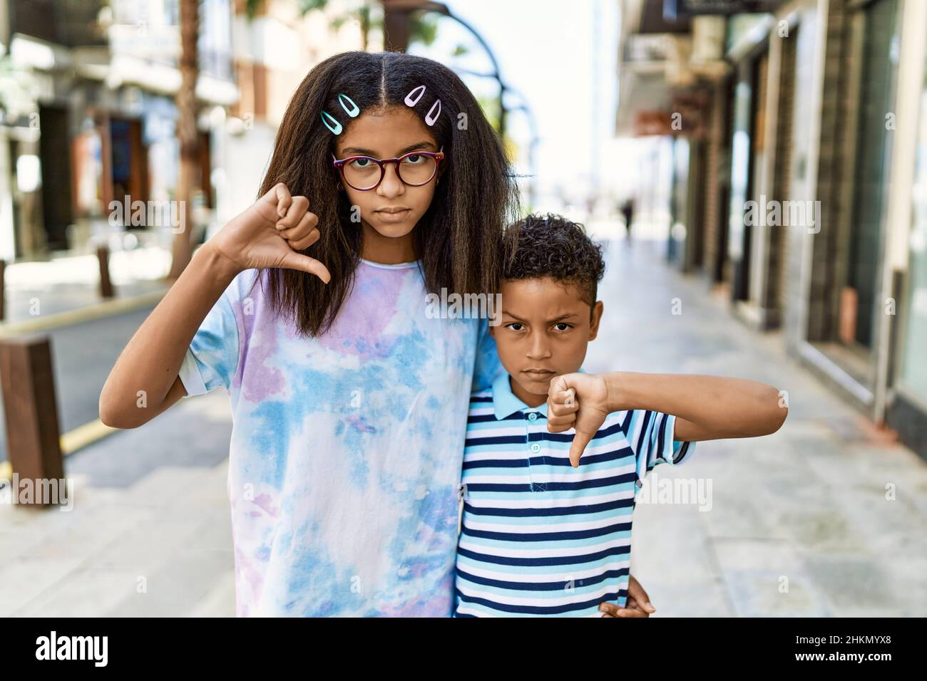 African american family of bother and sister standing at the street with angry face, negative ...