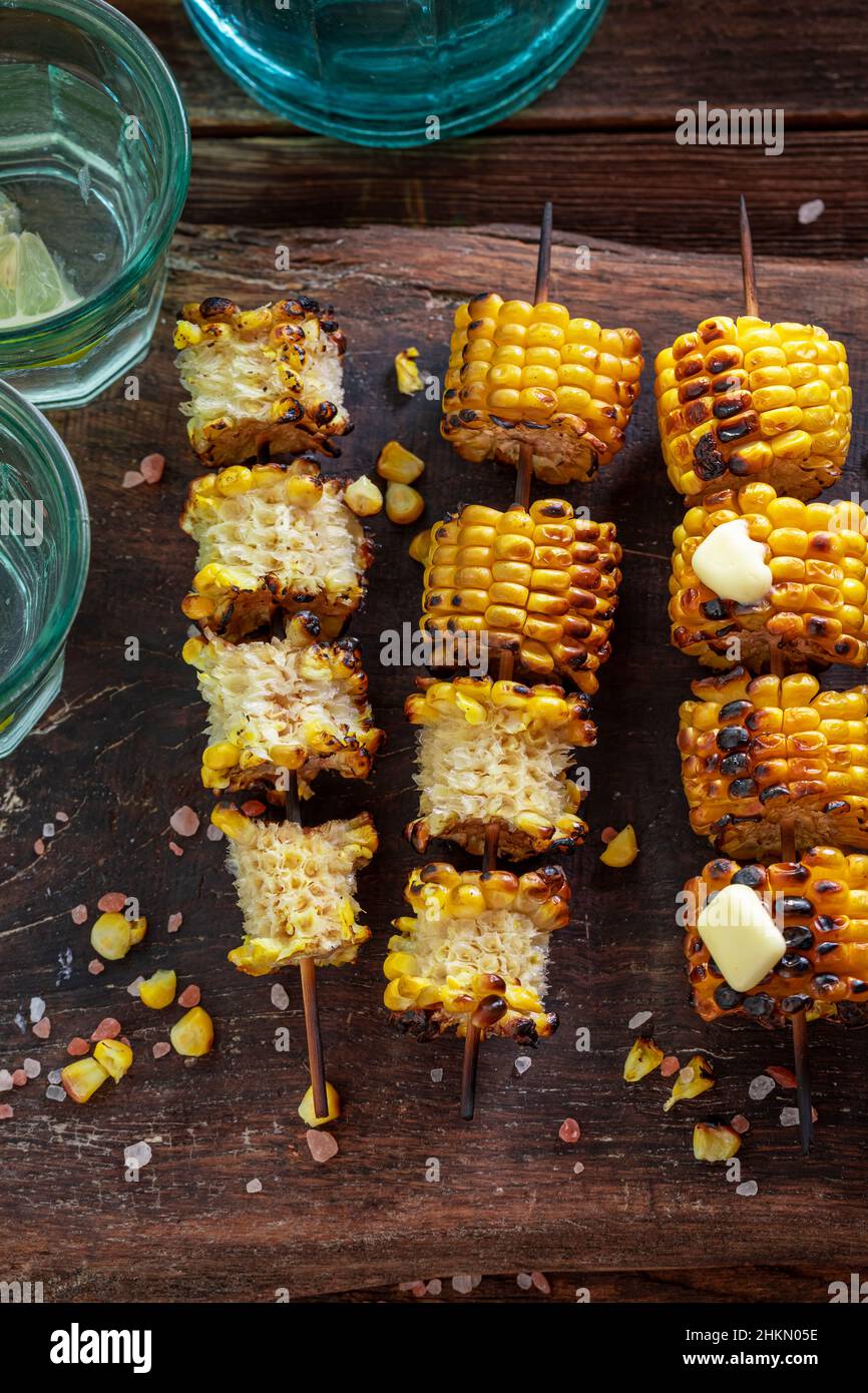 Homemade grilled corn cob as summer delicacy in garden. Roasted corn on ...