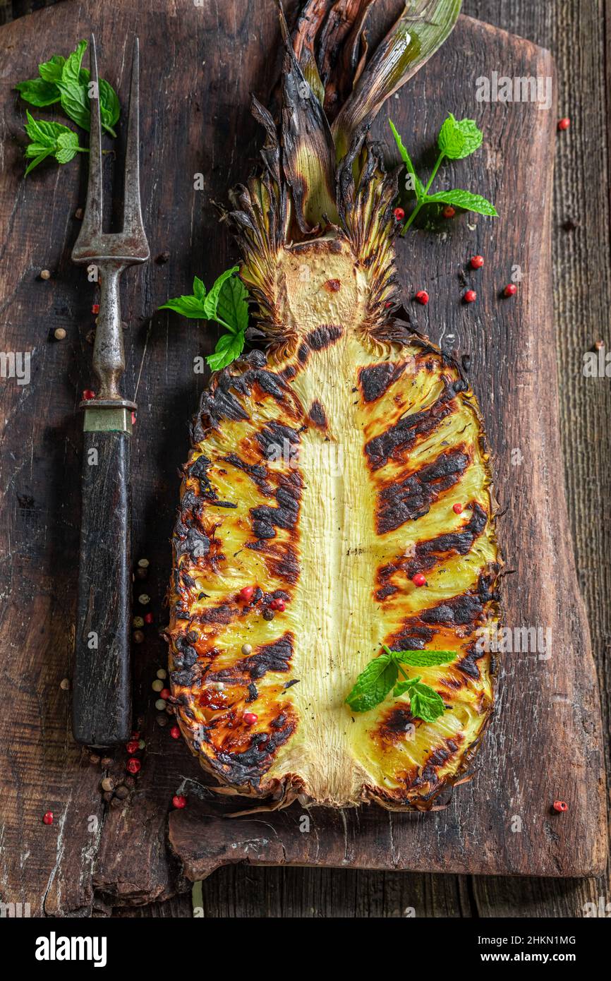 Sweet roasted pineapple on grill grate with fire. Grilled ananas on ...