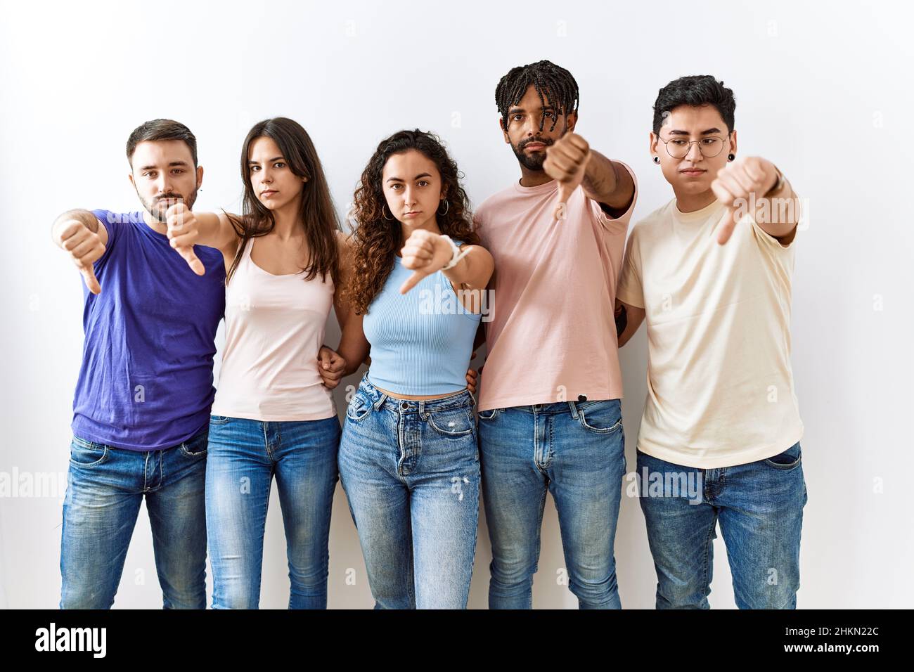 Group of young people standing together over isolated background ...