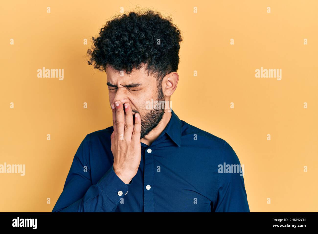 Young arab man with beard wearing casual shirt bored yawning tired ...