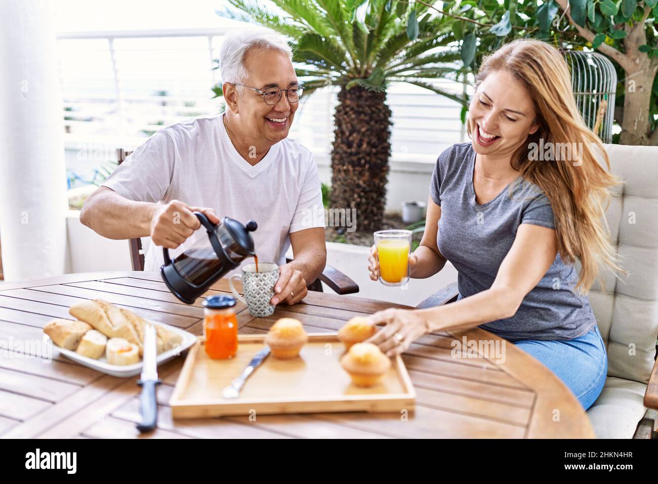Middle age hispanic couple smiling happy having breakfast at the ...