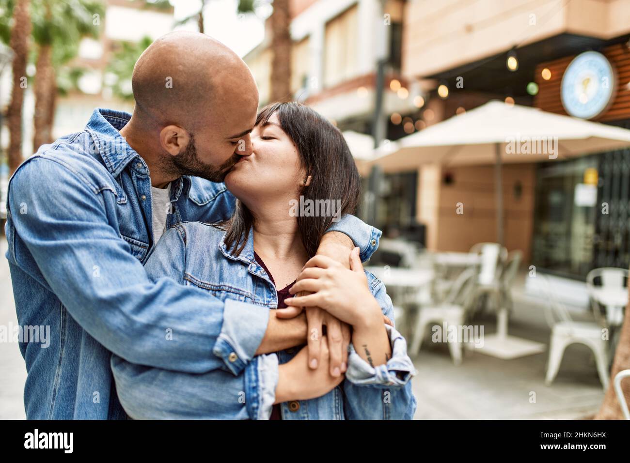 Young hispanic couple kissing and hugging at the city Stock Photo - Alamy