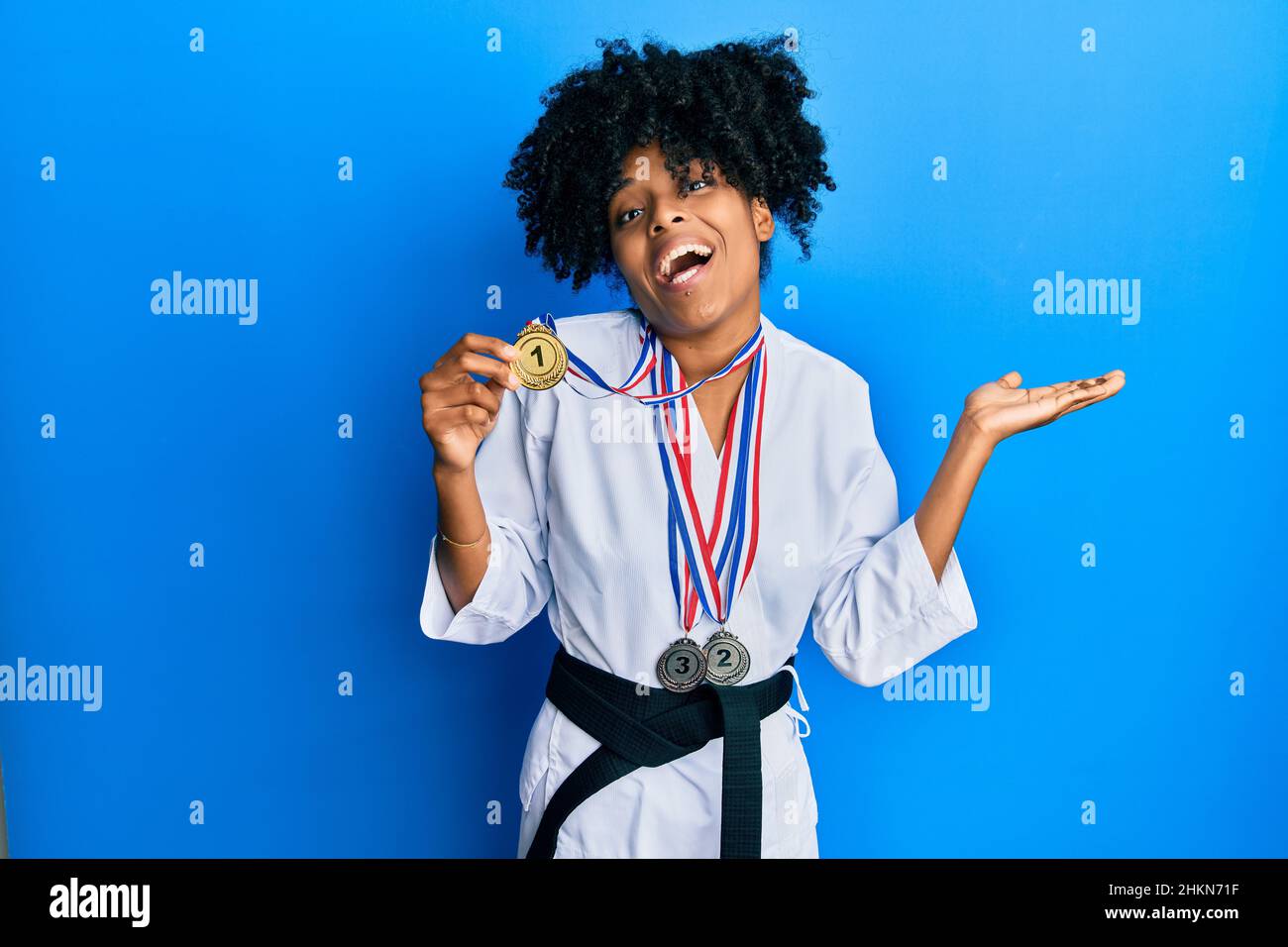 African american woman with afro hair wearing karate kimono and black ...