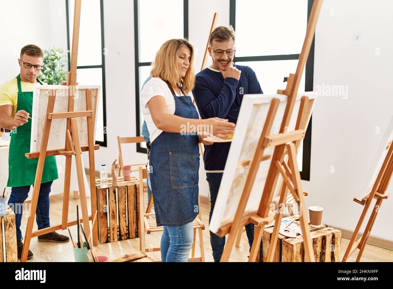 Group of middle age paint students drawing at art studio. Teacher ...