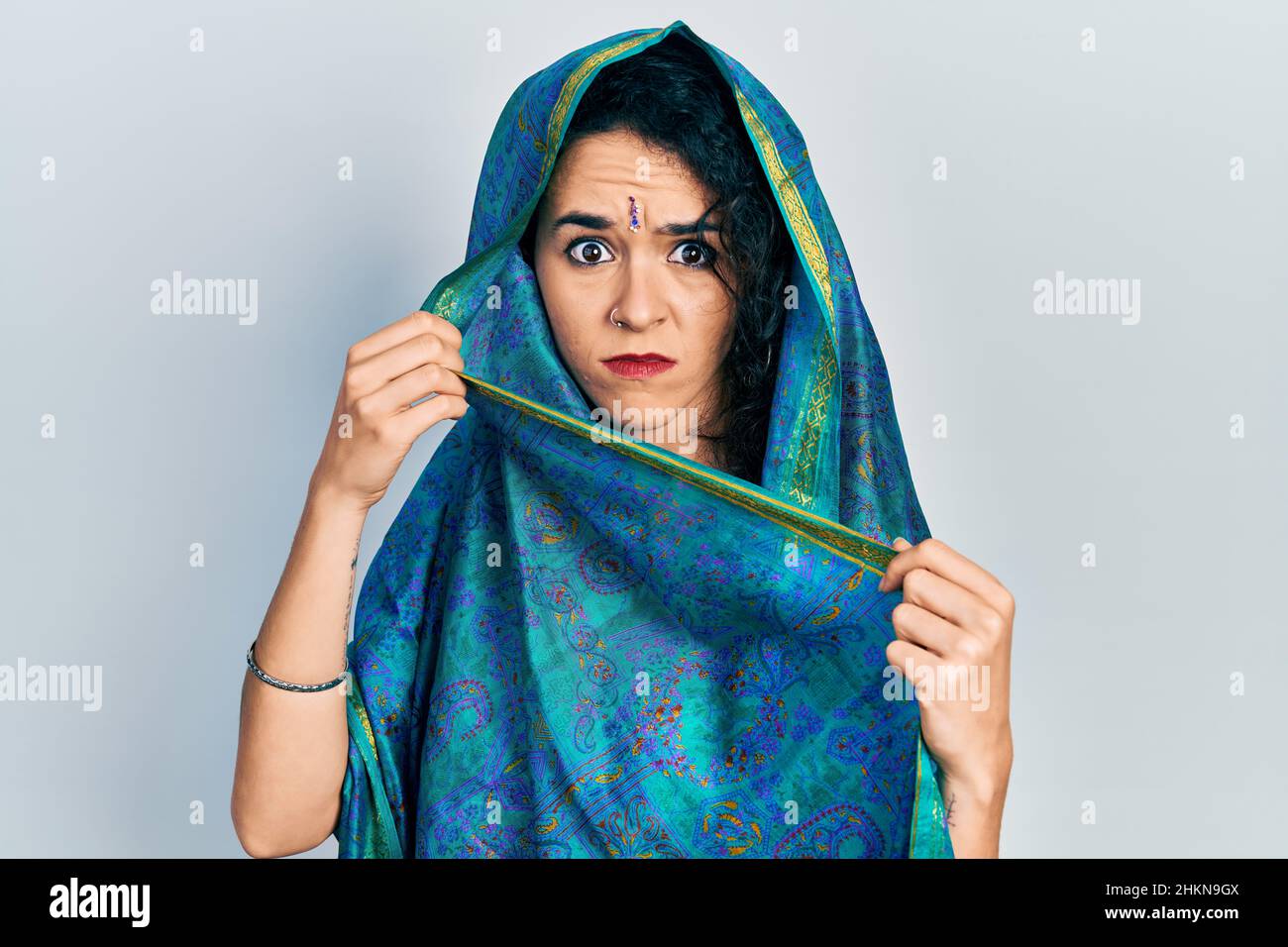 Young woman wearing bindi wearing traditional indian saree shouting and ...