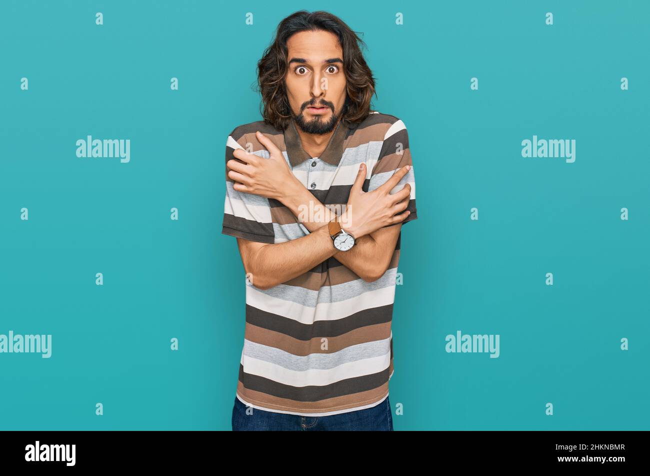 Young hispanic man wearing casual clothes shaking and freezing for ...