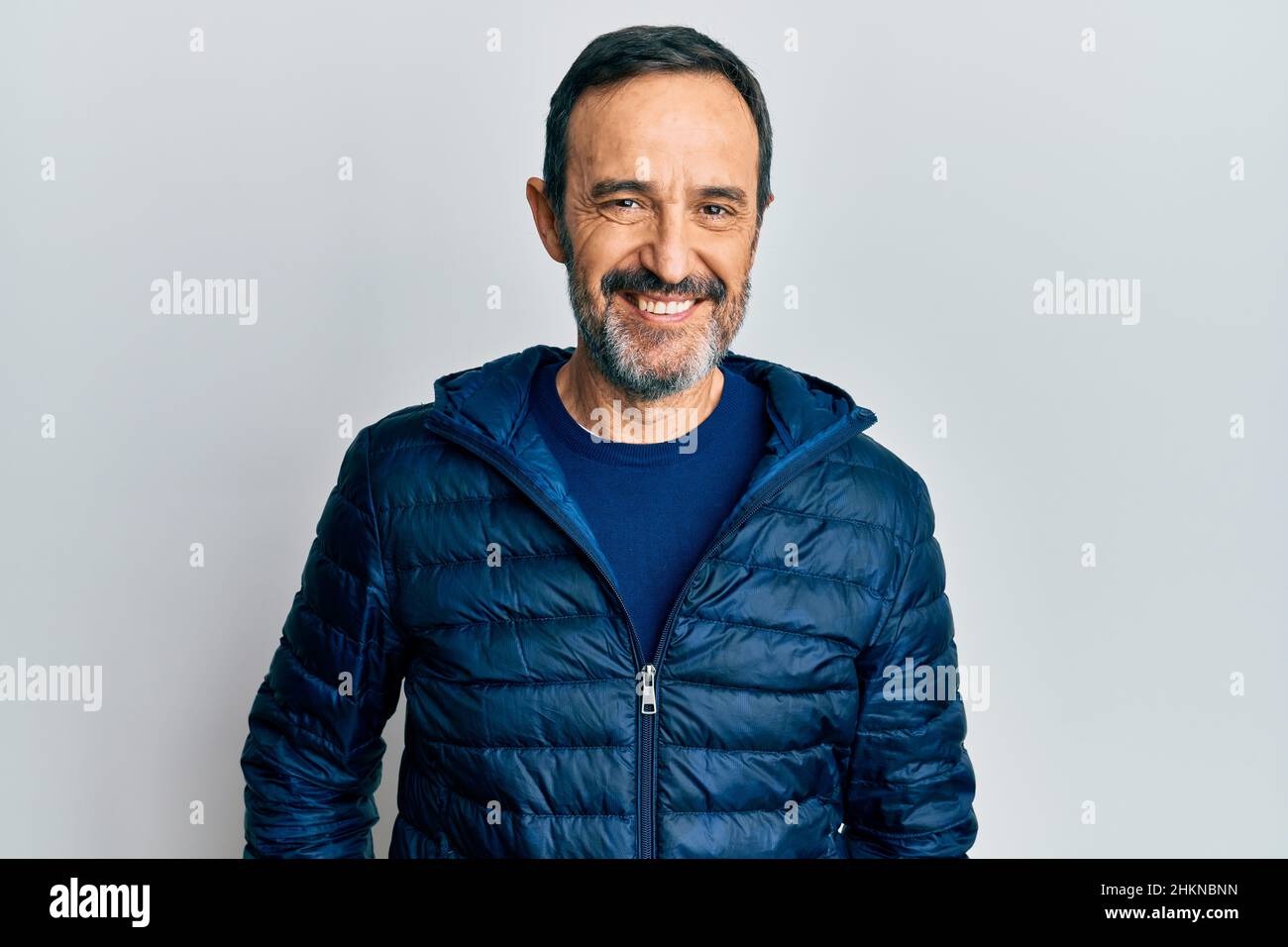 Middle age hispanic man wearing casual clothes looking positive and ...