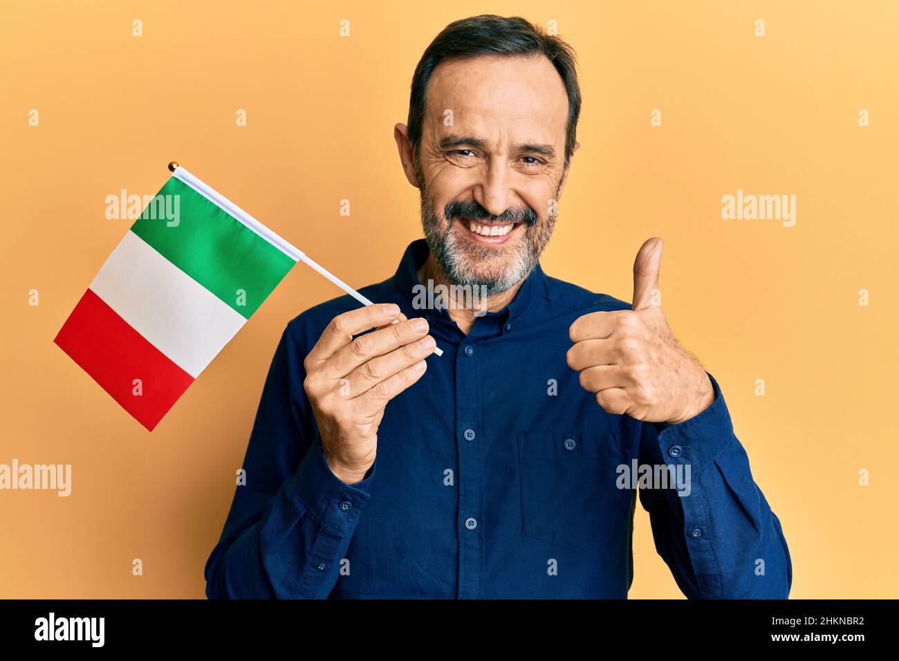 Middle age hispanic man holding italy flag smiling happy and positive ...