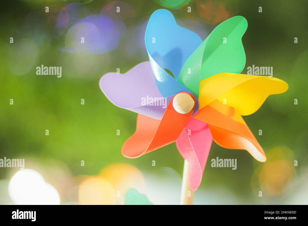 Colorful rainbow pinwheel toy with golden bokeh abstract funny ...