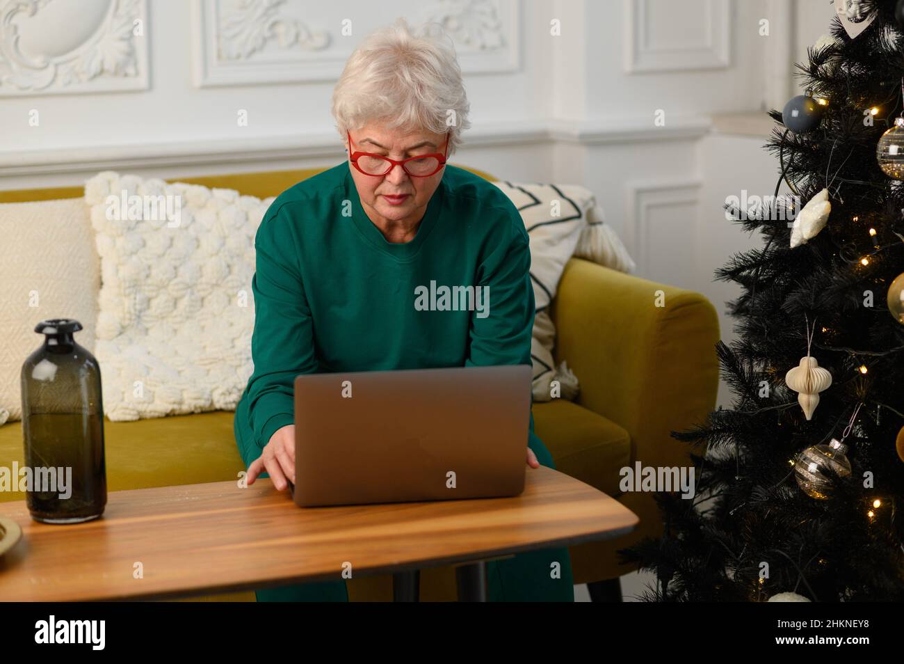 grandma is talking on a video conference with her family. Modern means ...