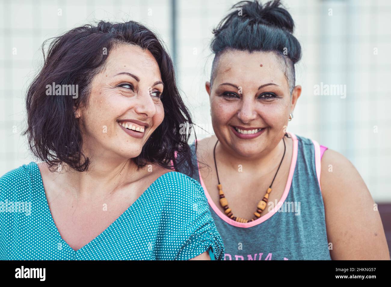 Portrait of two adult brunette twin sisters. Different styles Stock ...