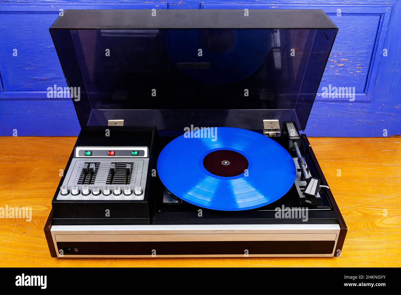 Vintage turntable vinyl record player with blue vinyl on a table Stock ...