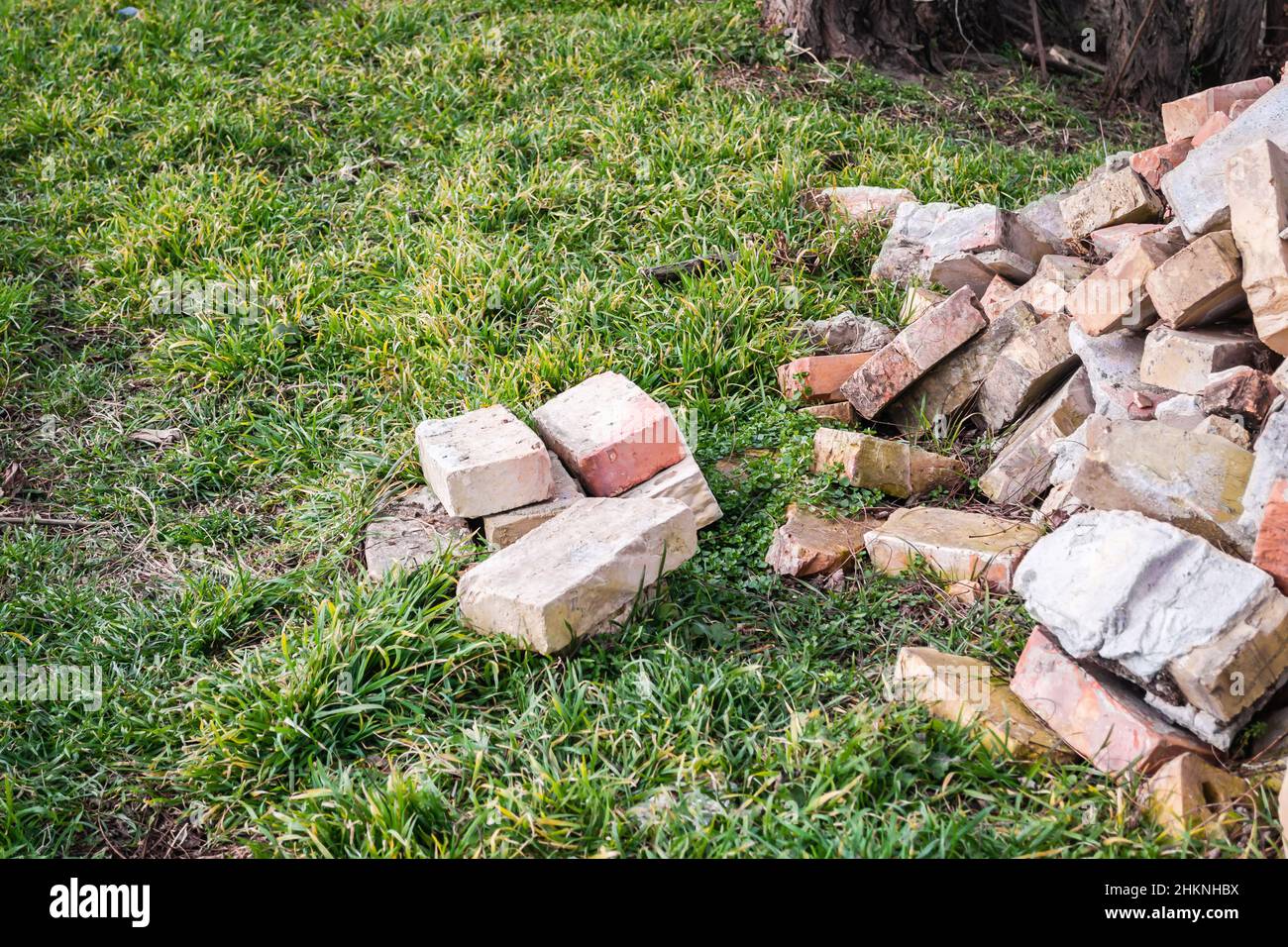 A pile of old used bricks with scratches and cracks from the old wall ...