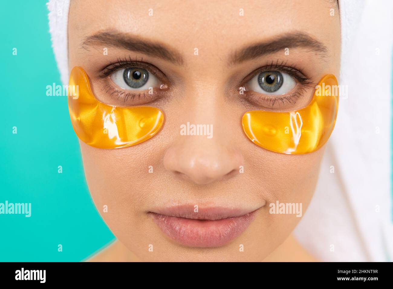 closeup of young lady has collagen golden eye patches on face with ...