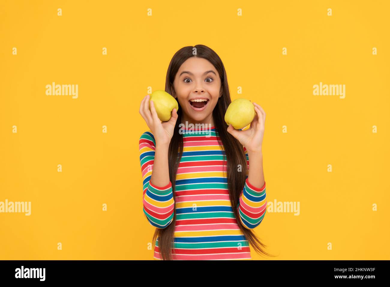 Happy kid hold apples for healthy teeth yellow background, smile Stock ...