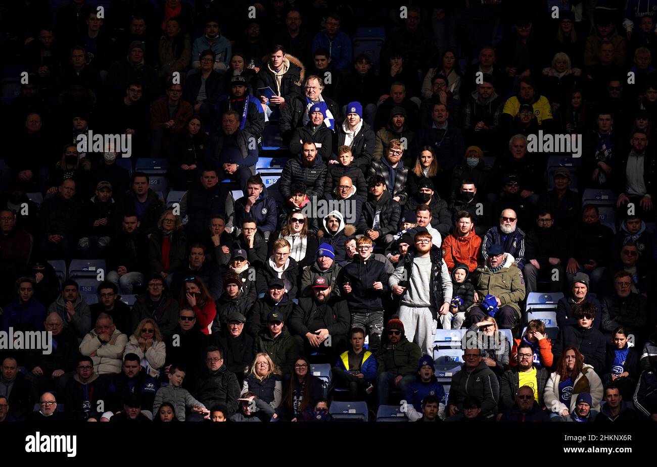 Chelsea fans are illuminated by the sunlight in the stands during the ...