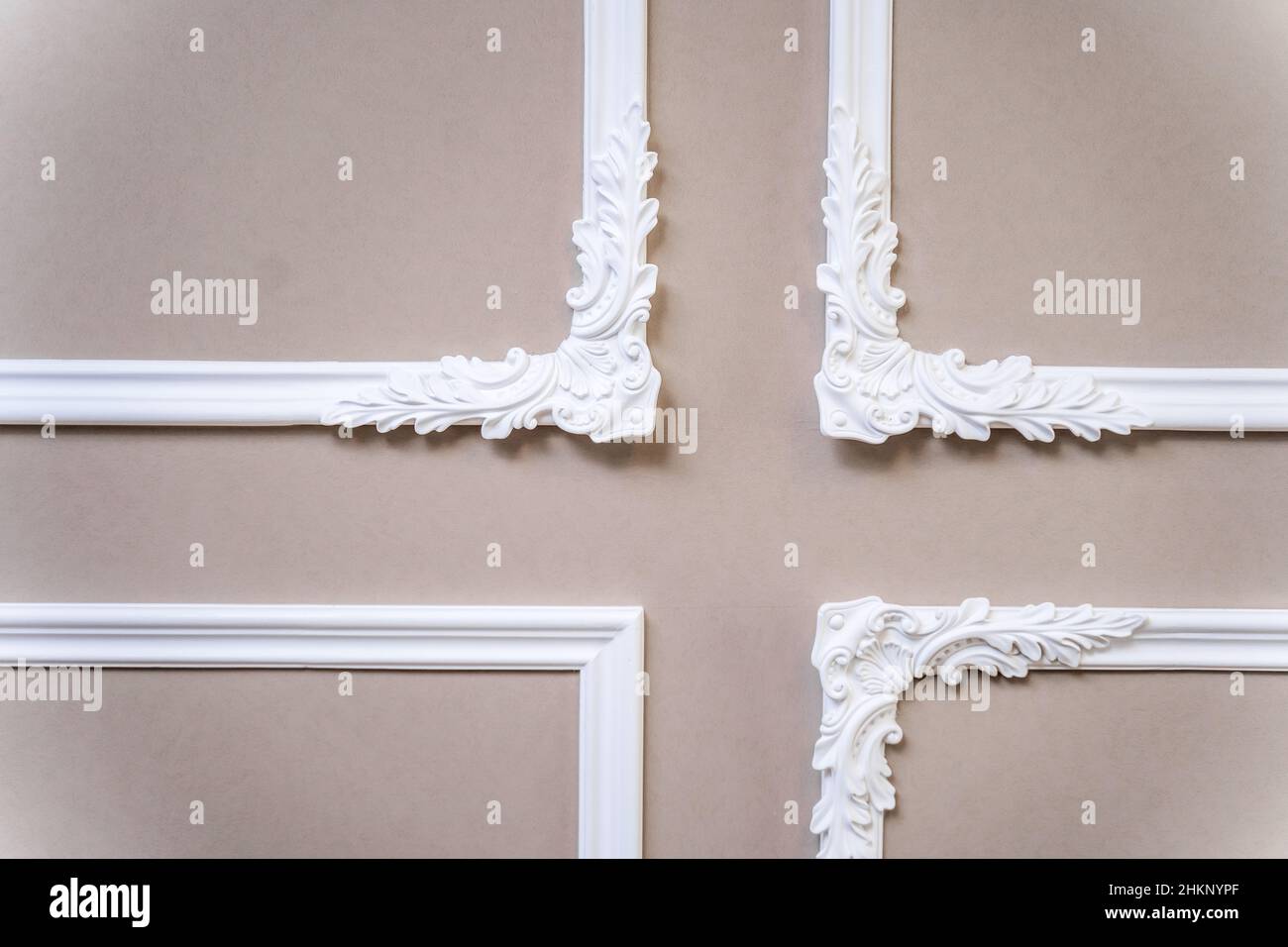 The panel is a plaster frame with patterned corners on the wall of the ...