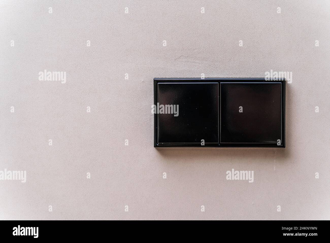 Stylish black light switches on the wall in a newly renovated room ...