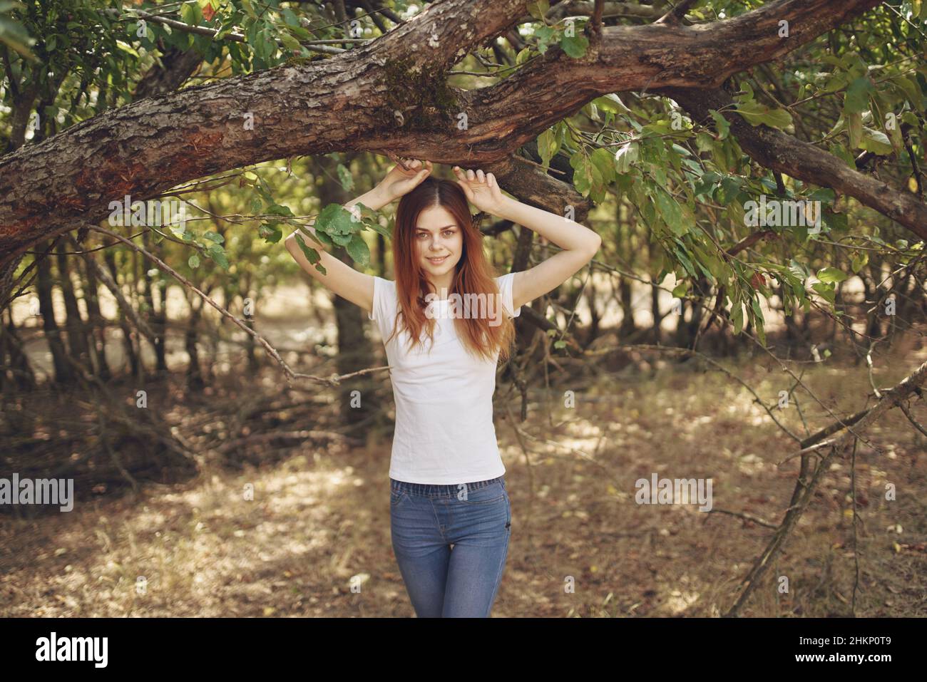 woman touching tree branch with hands on nature in summer garden Stock ...