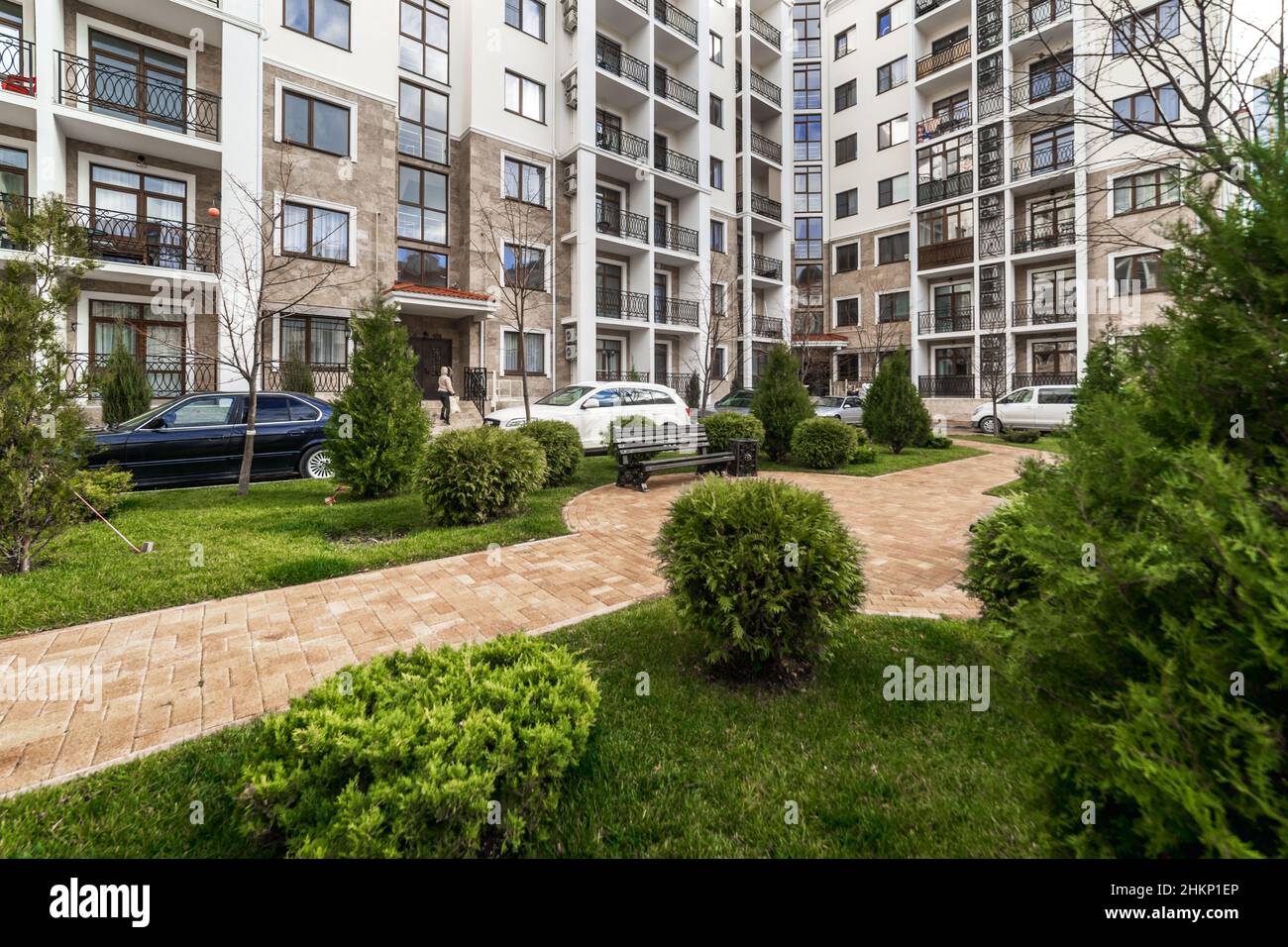 a small cozy green courtyard with benches in the courtyard of a multi ...