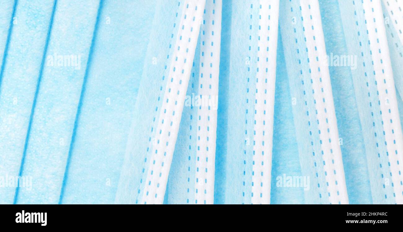 Multiple protective surgical face masks wide banner bright background ...